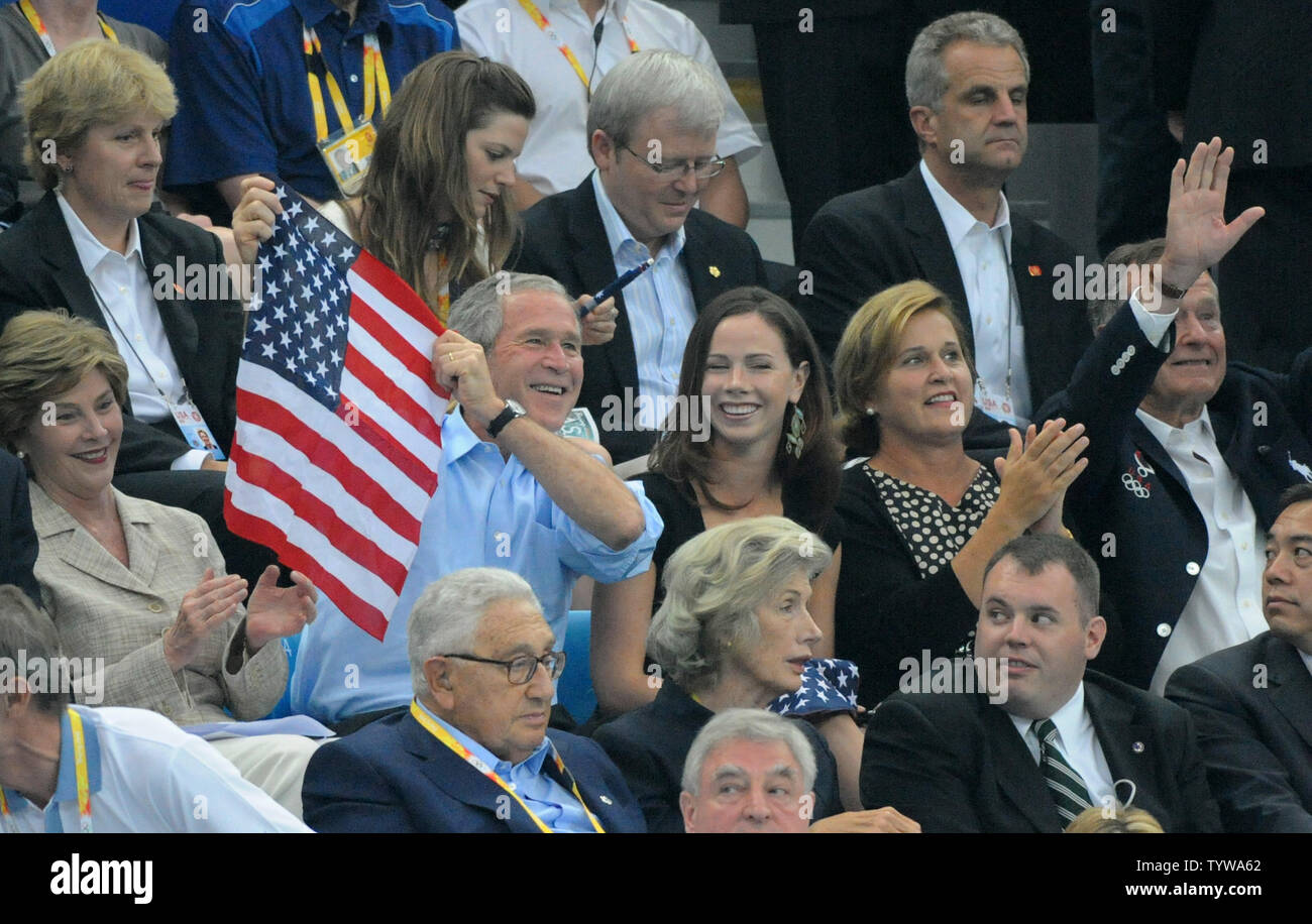 United States President George W. Bush holds up the American flag as he ...