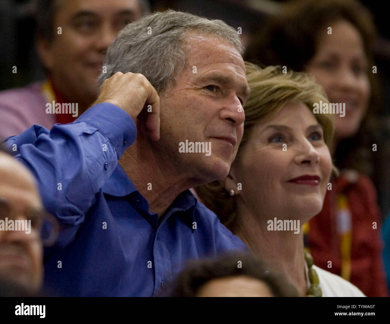 U.S. President George W. Bush (L) and his wife Laura watch USA and ...