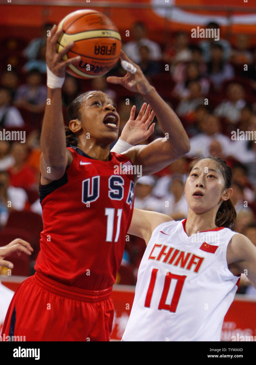 USA's Tina Thompson (11) goes up in front of Sui Feifei of China at the ...