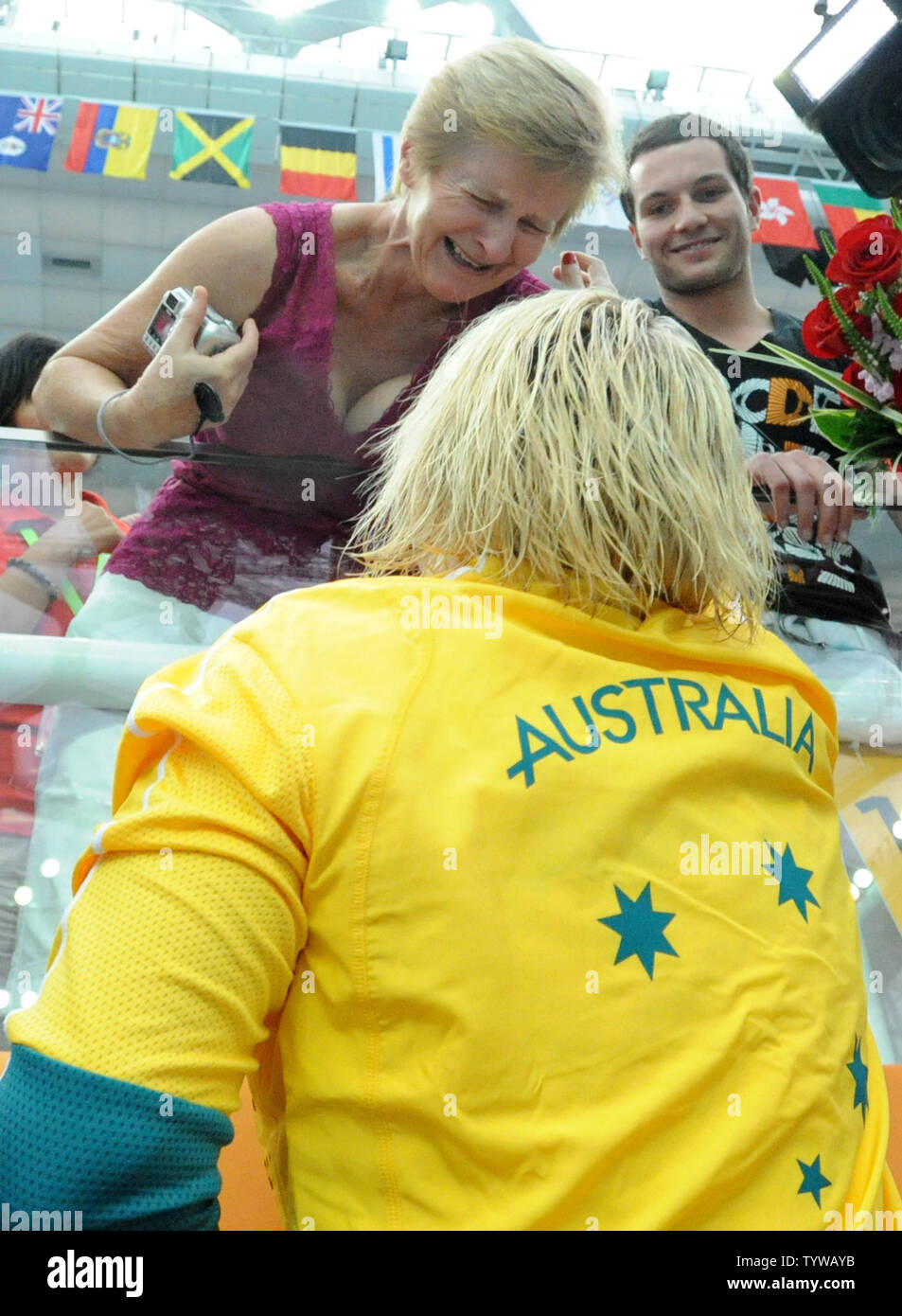 Australia's gold medal winner Leisel Jones goes into the crowd to hug ...