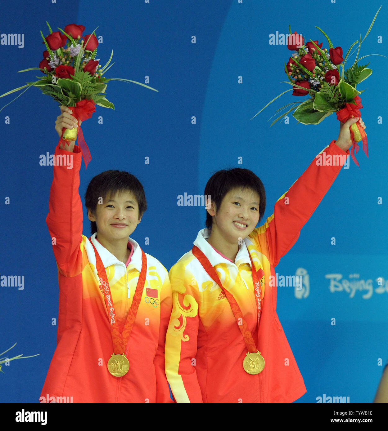 Chinese divers Xin Wang and Ruolin Chen wave after receiving medals for Women's 10M Synchro ...