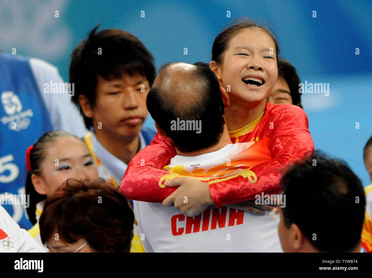 China's Fei Cheng is lifted by her coach Lu Shanzhen in jubilation as ...