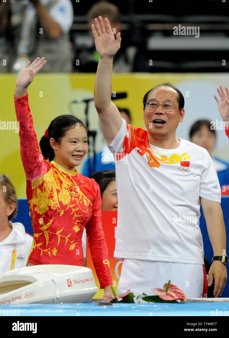 China's Fei Cheng and China's coach Lu Shanzhen wave to the crowd after ...