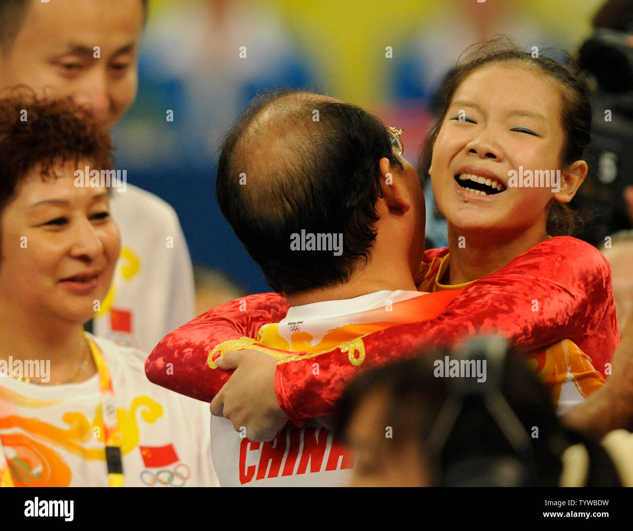 Chinese gymnast Cheng Fei leaps into the arms of coach Lu Shanzhen ...