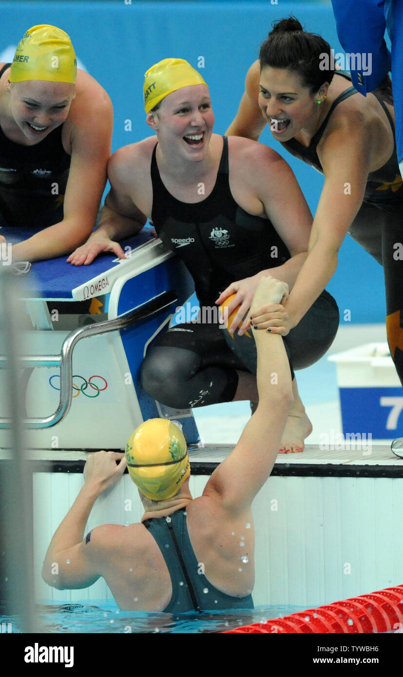 Australia's gold medal winners Stephanie Rice (R), Bronte Barratt (C), Kylie Palmer (L) cheer ...