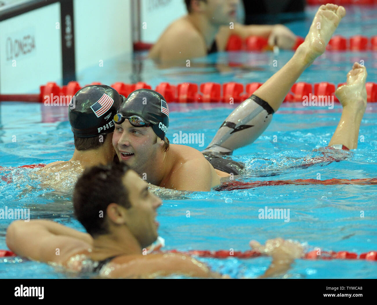 USA's Michael Phelps (L) is congratulated by team mate Ian Crocker as ...