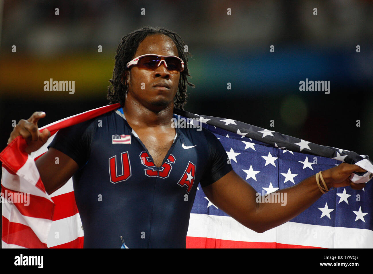 USA's Walter Dix carries an American flag on a victory lap after ...