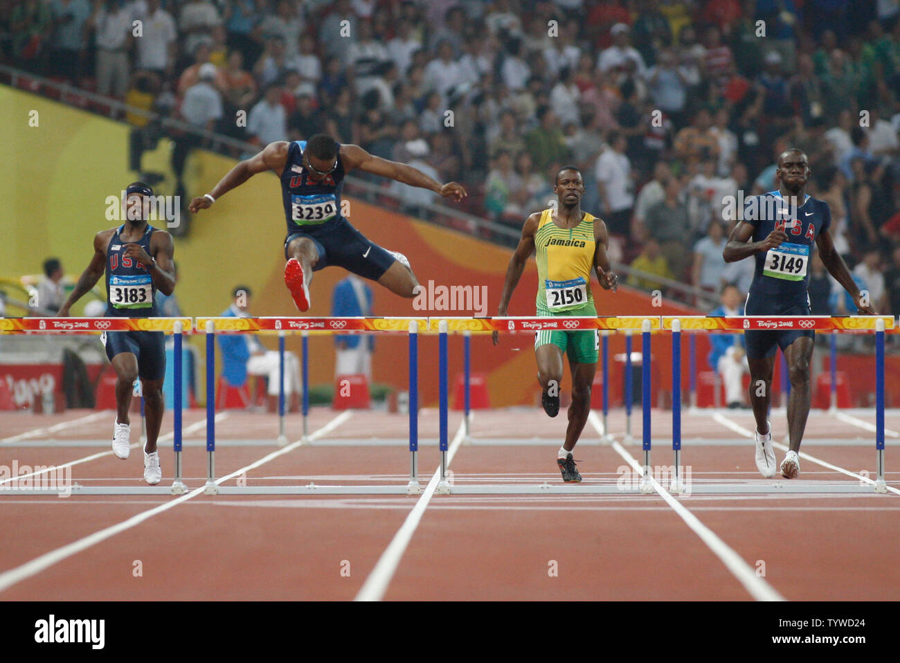USA's Angelo Taylor (3239)takes the final hurdle and gold in the 400m ...