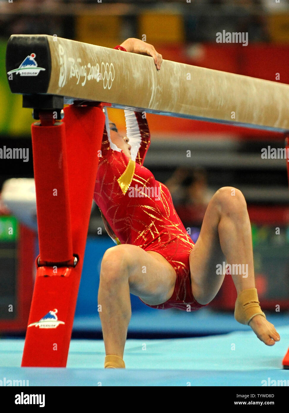 Chinese gymnast Li Shanshan grabs the beam after falling off during her ...