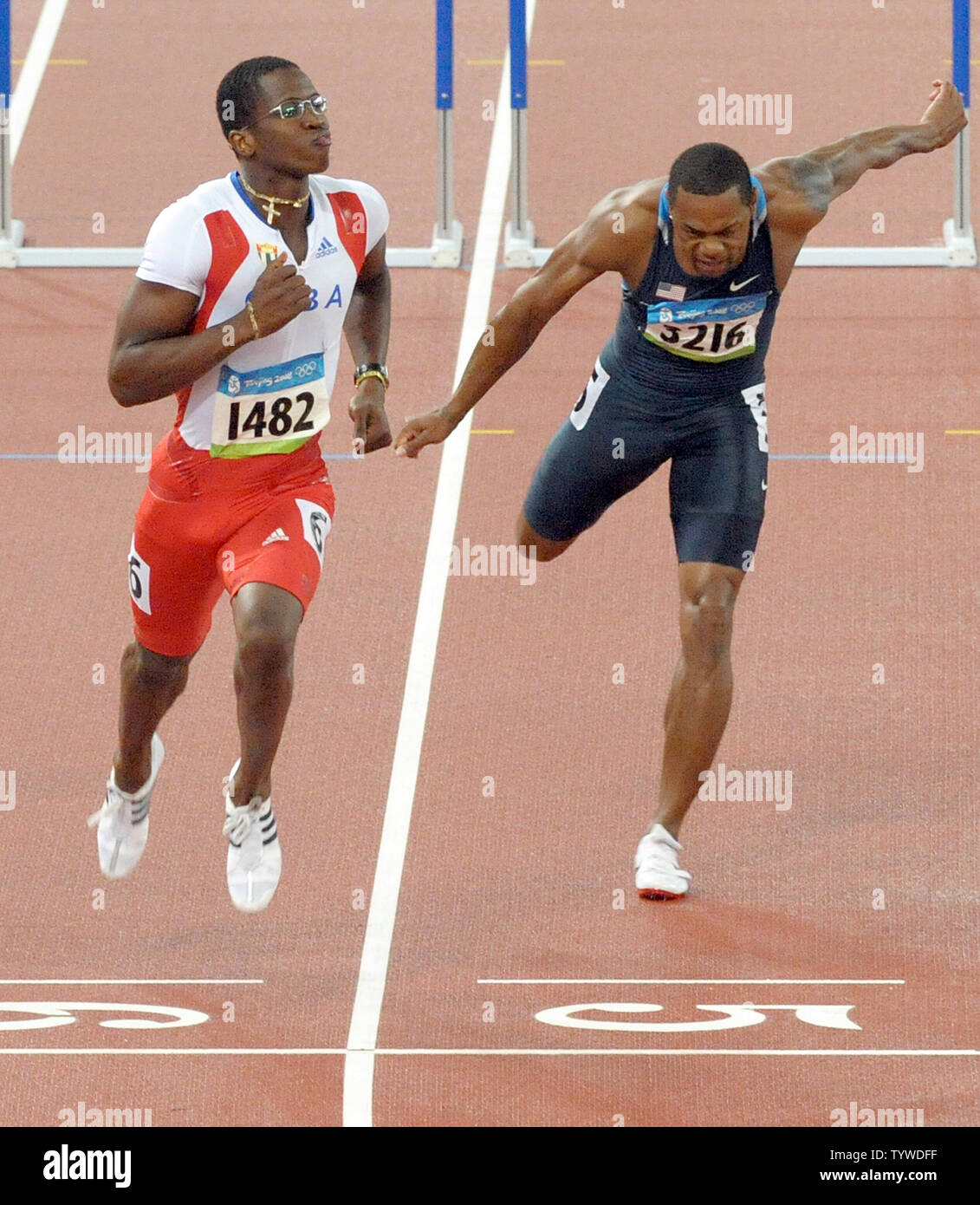 Cuba's Dayron Robles looks up at the score board as he coasts across ...