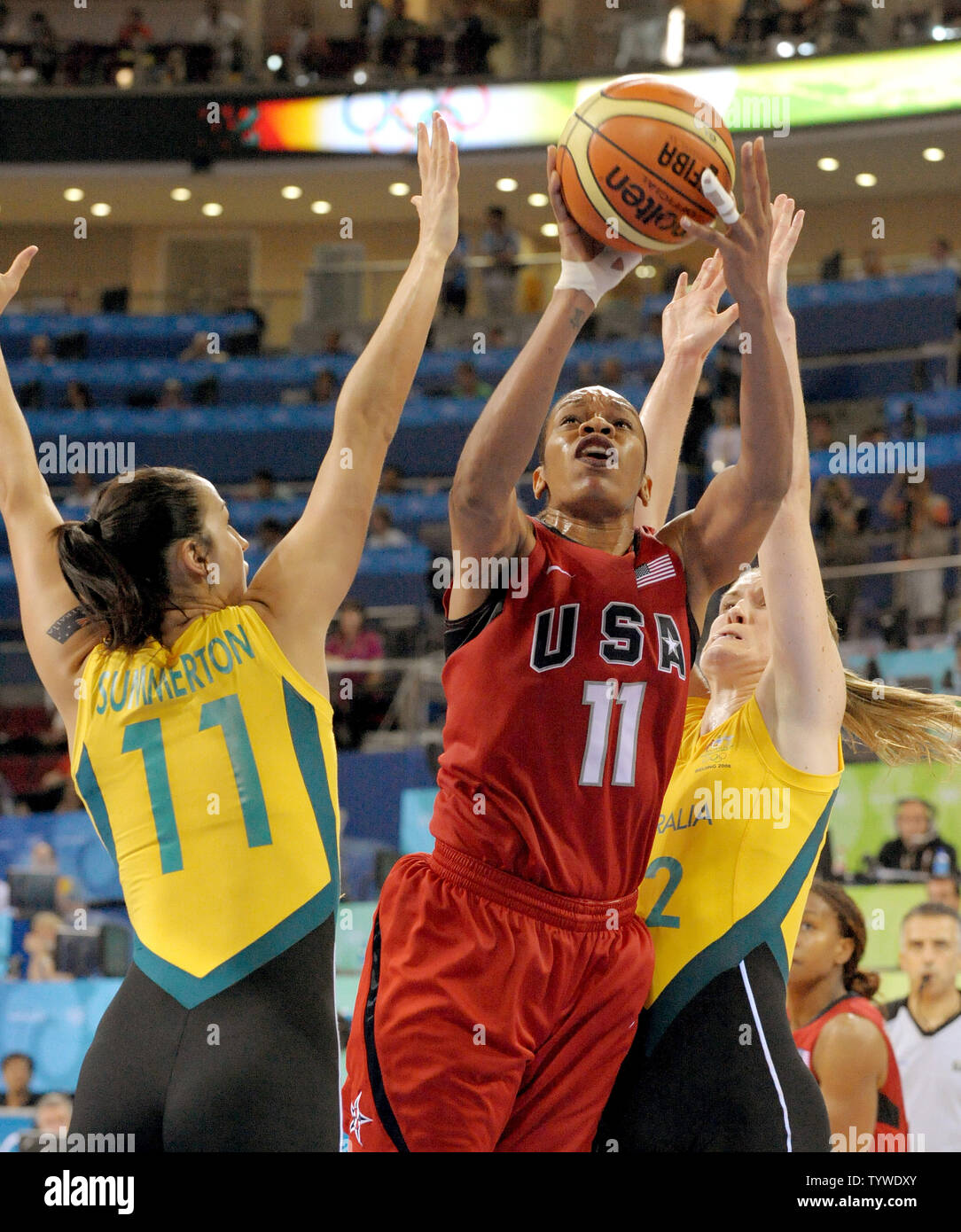 USA's Tina Thompson shoots past Australia's Laura Summerton and ...