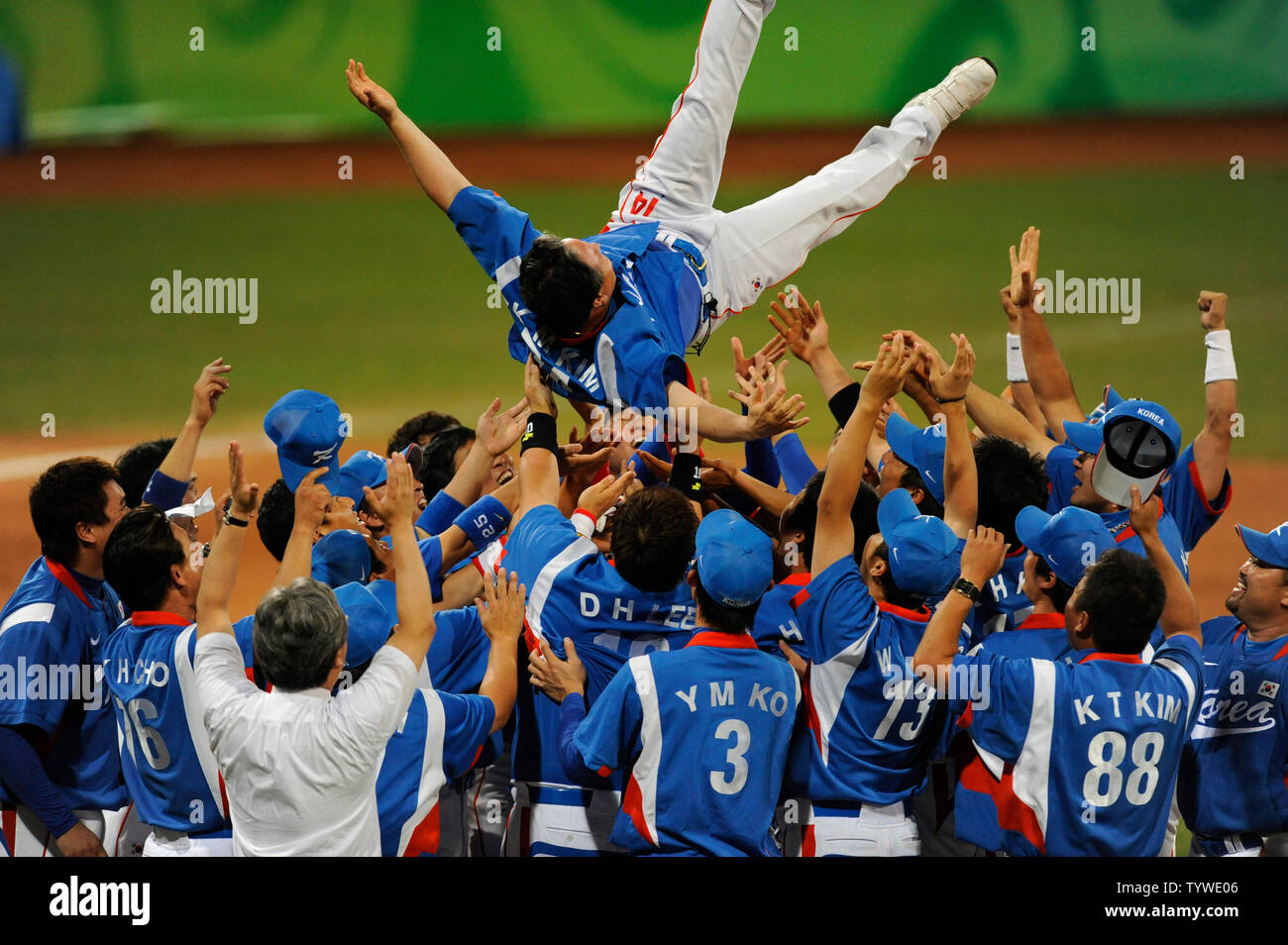 Korea's team throws coach Kyungmoon Kim into the air in jubilation ...