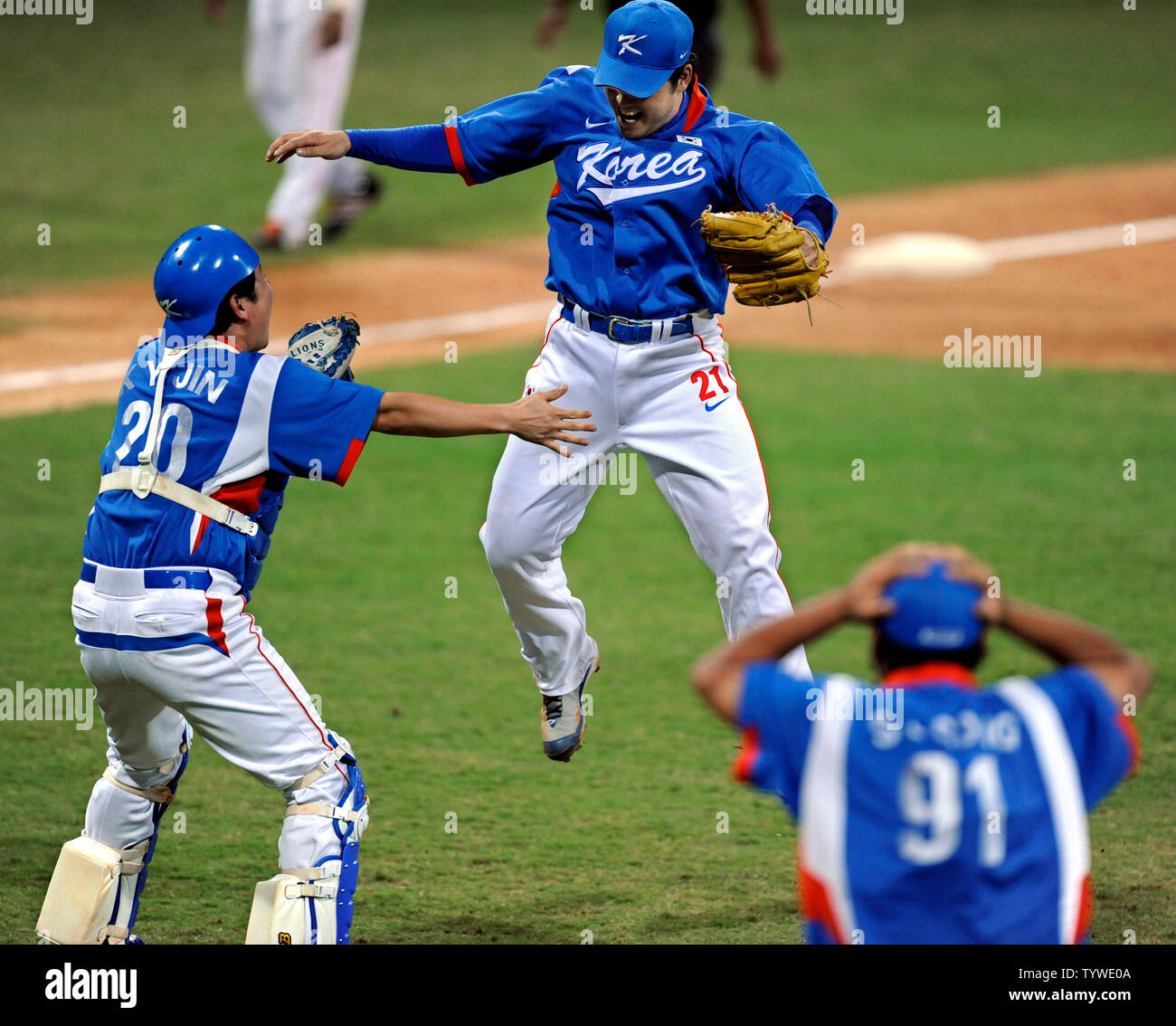 Korea's relief pitcher Taehyon Chong (R) leaps in the air after getting ...