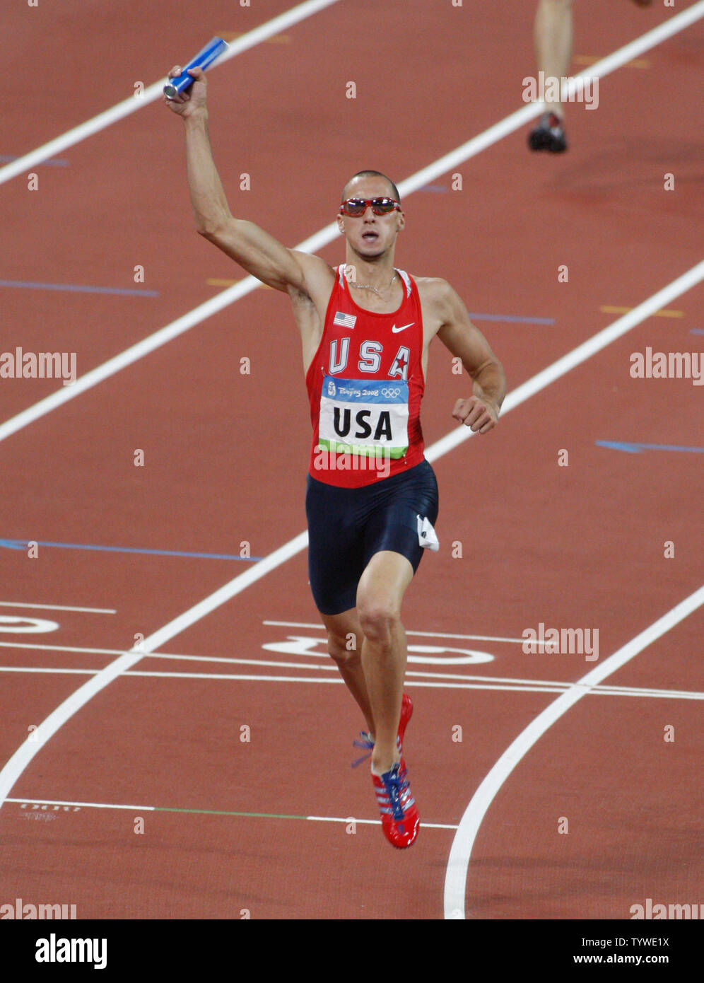 Anchor Jeremy Warner of the USA men's 4x400m relay team, holds the ...