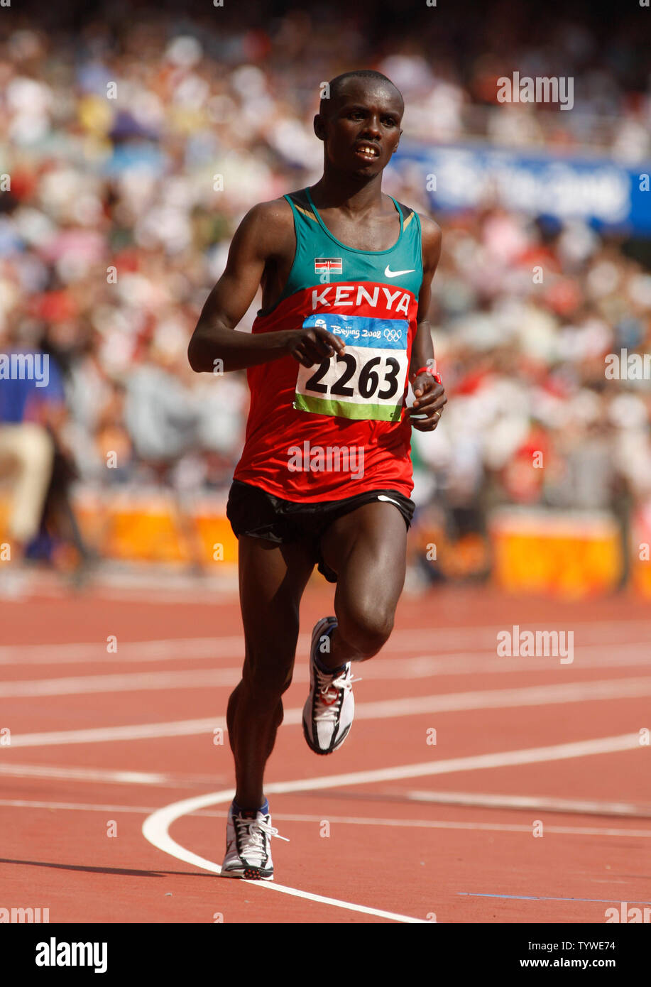 Samuel Kamau Wanjiru of Kenya runs a final lap in the National Stadium ...