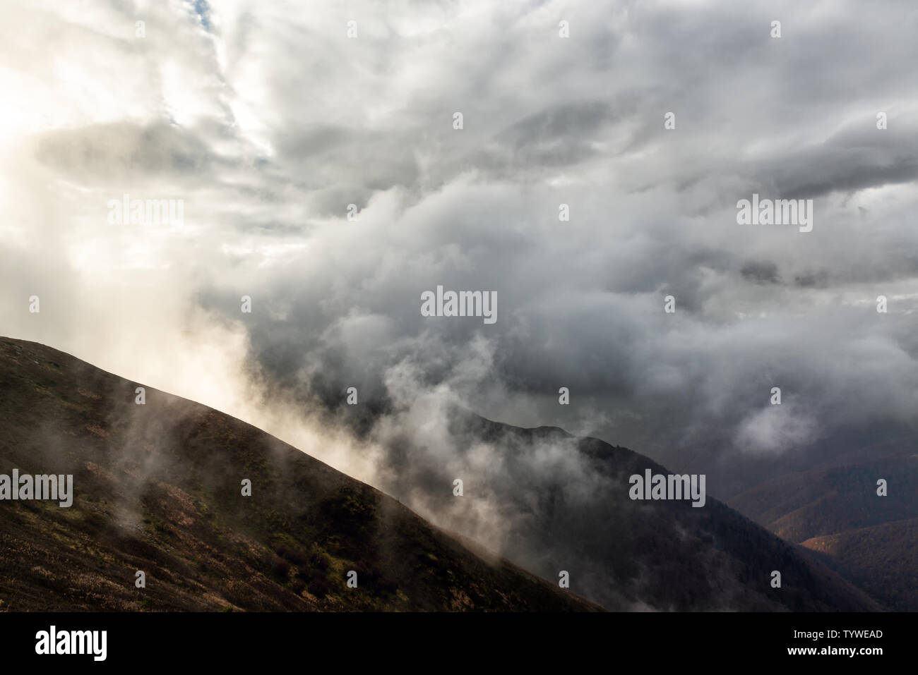 Rain clouds on the mountain hills. Dramatic landscape with bad weather ...