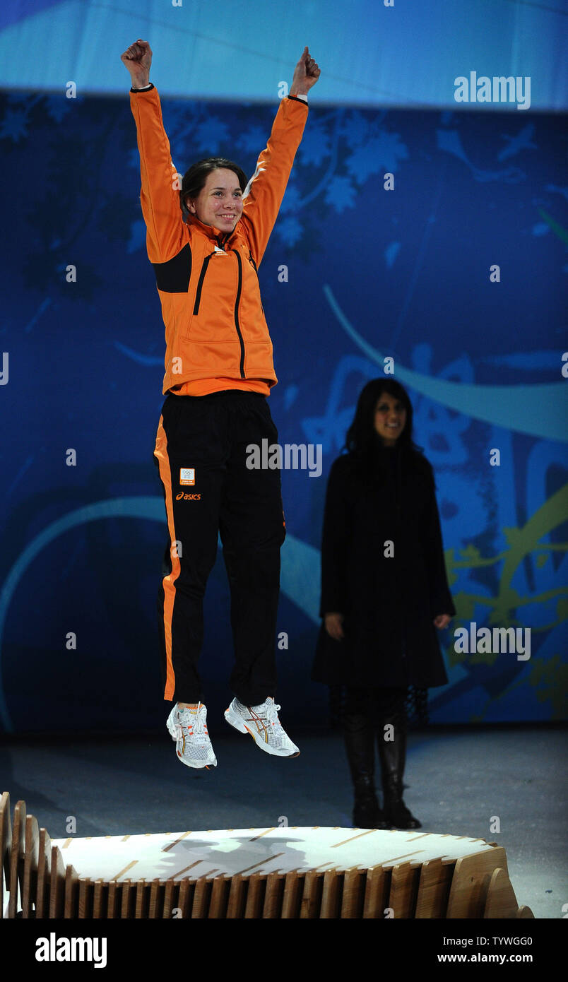 Laurine van Riessen of the Netherlands jumps to the podium celebrating ...