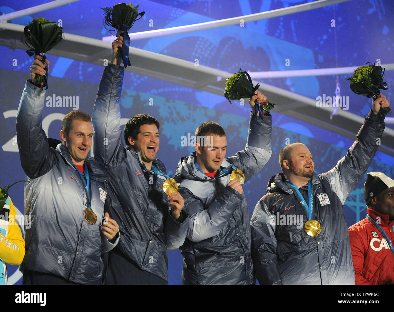 The USA's four-man bobsled team celebrates with their gold medals ...