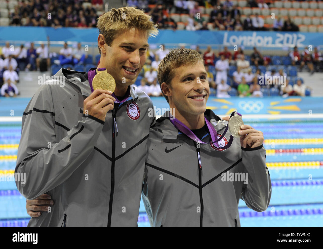 American swimmer Matthew Grevers (L) holds his gold medal along with fellow American Nick Thoman ...