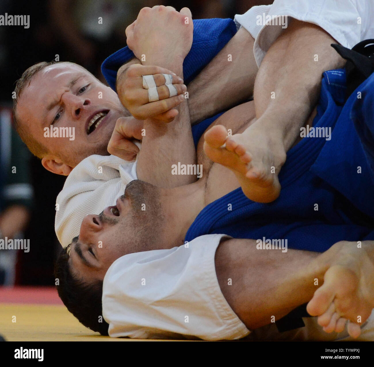 Dimitri Peters of Germany (White) tangles with gold medalist Tagir ...