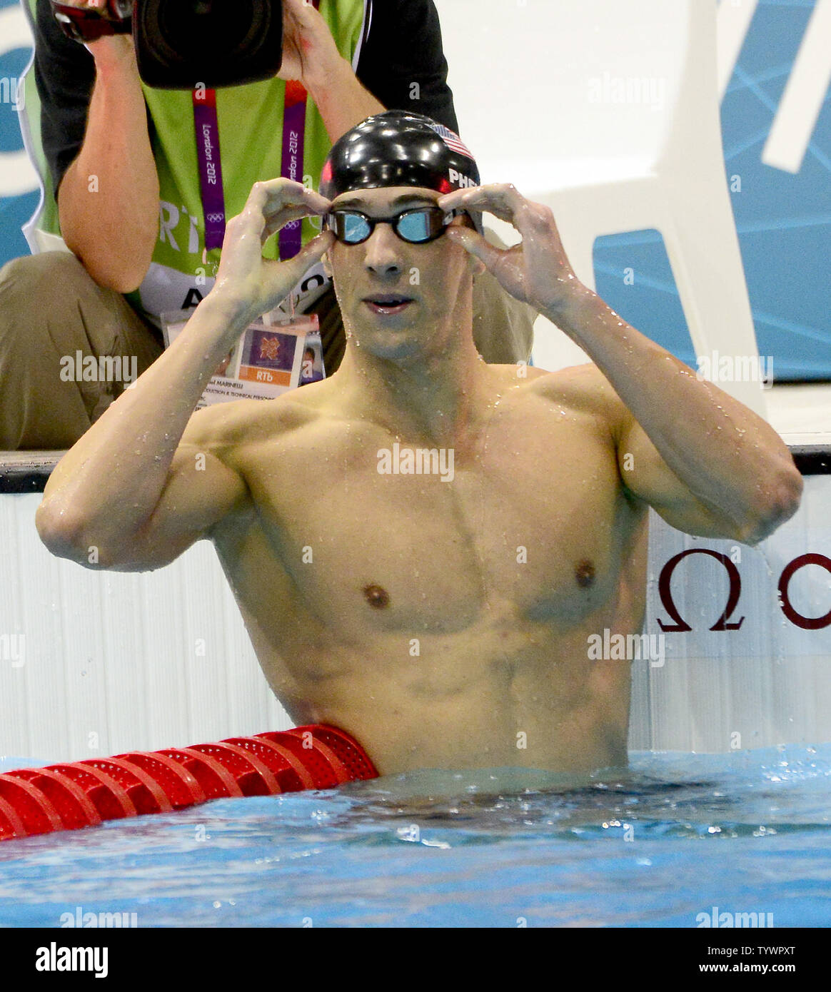 Michael Phelps looks back at the scoreboard after winning gold in the ...