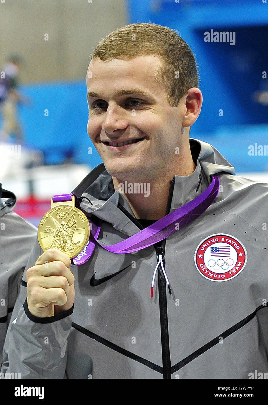 Tyler Clary of the United States shows off his Gold Medal after ...