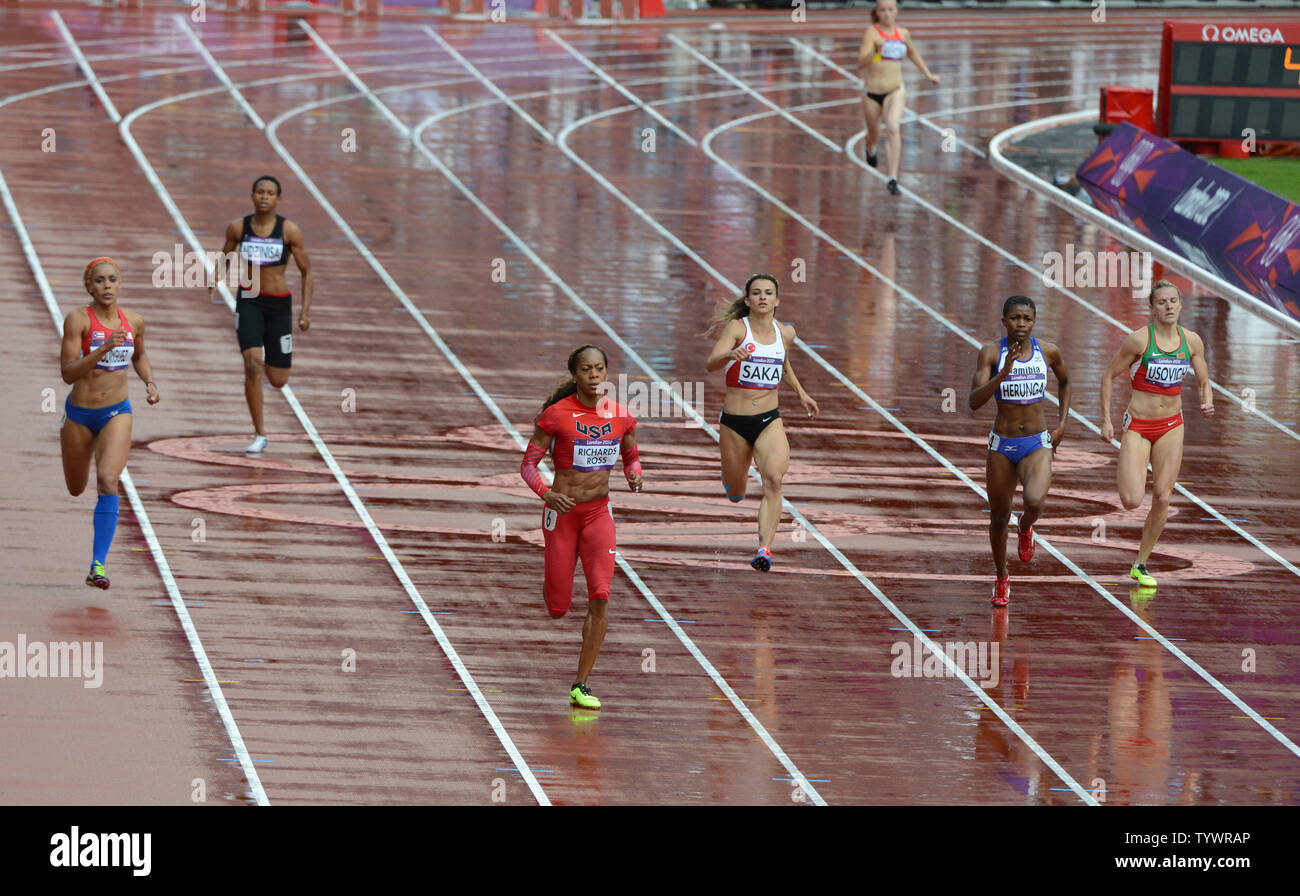 Sanya Richards-Ross (2nd L) leads the field running a rain soaked track ...