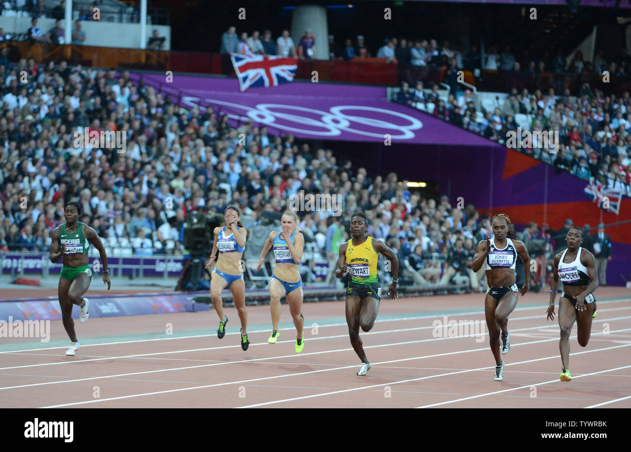 Runners fly down the track in a heat for the Women's 100M at the Track ...