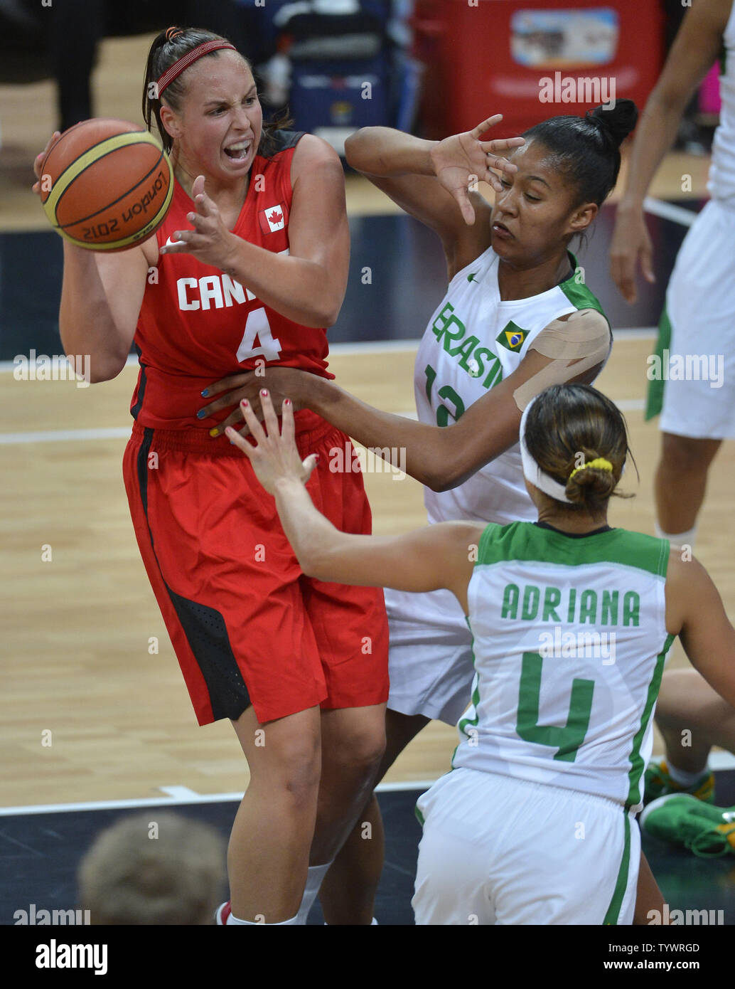 Canada's Krista Phillips (L) looks to pass off as she is defended by ...