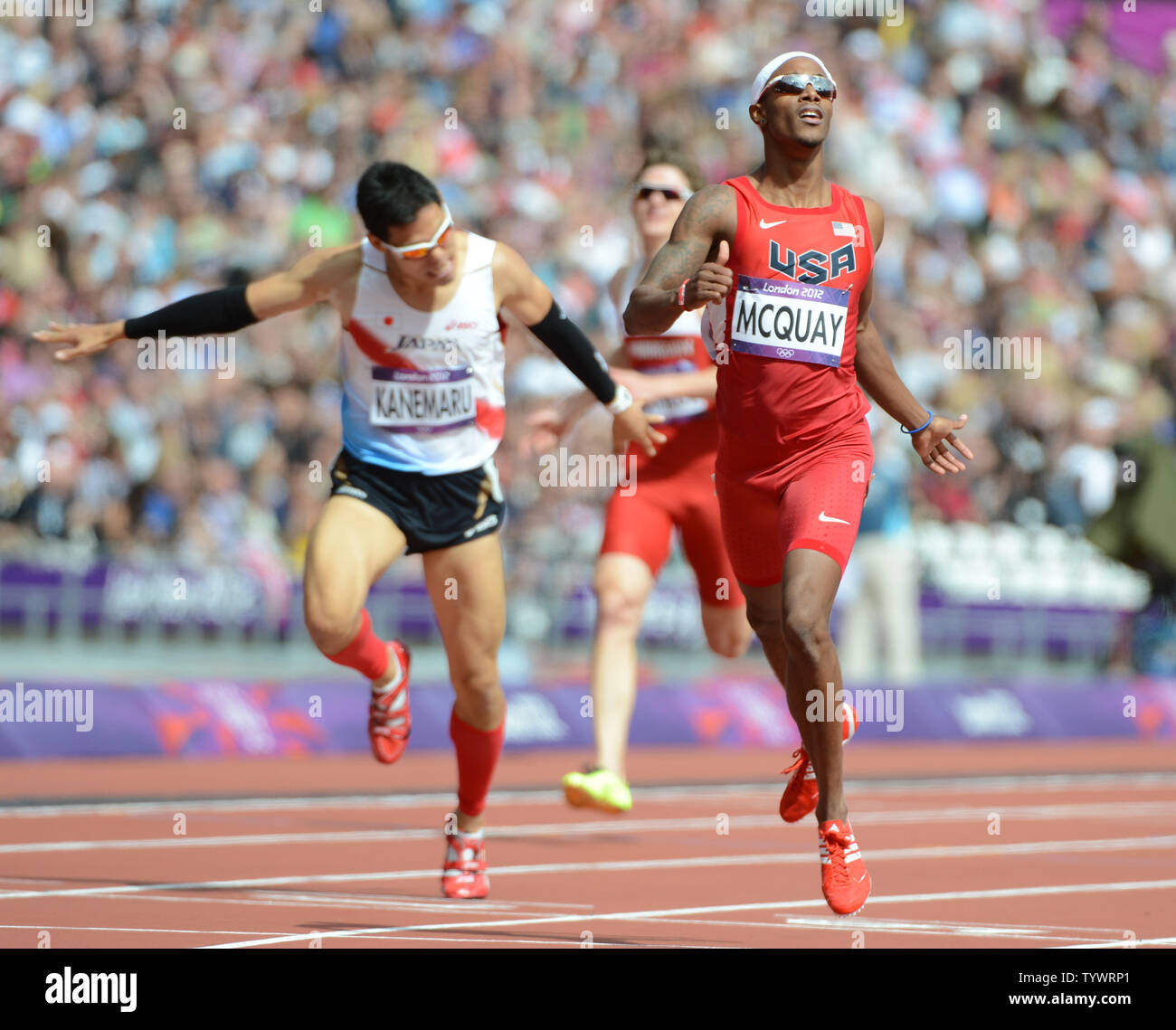 Tony McQuay of the USA (R) crosses the finish line ahead of Yuzo ...