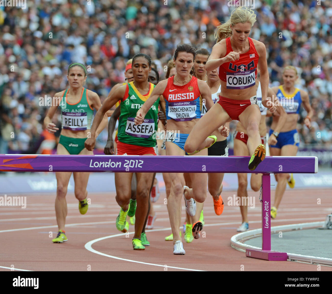 Emma Coburn of the USA leaps a hurdle in round one of the Women's 3000M ...
