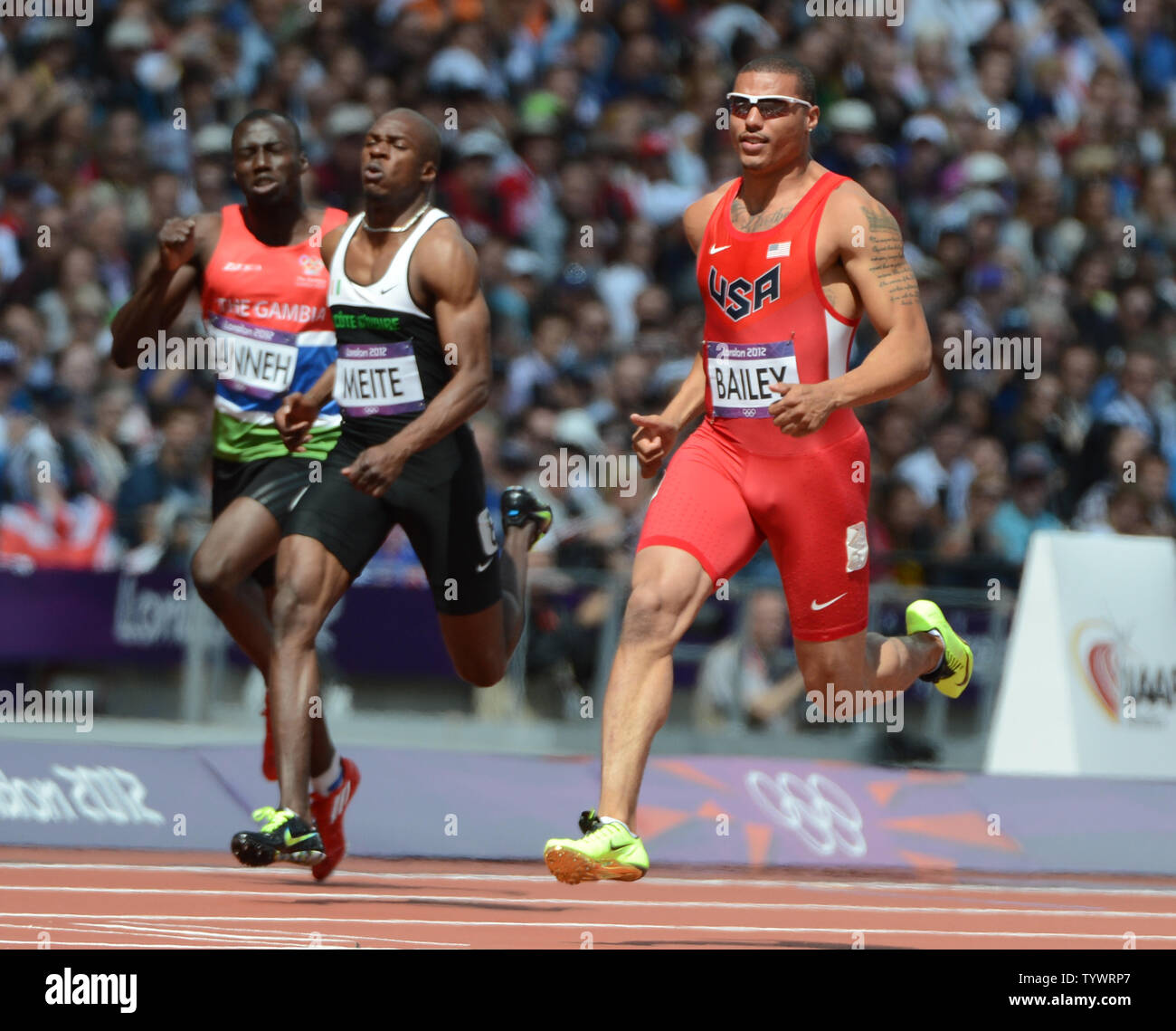 Ryan Bailey of the USA (R) crosses the finish line of round one of the ...
