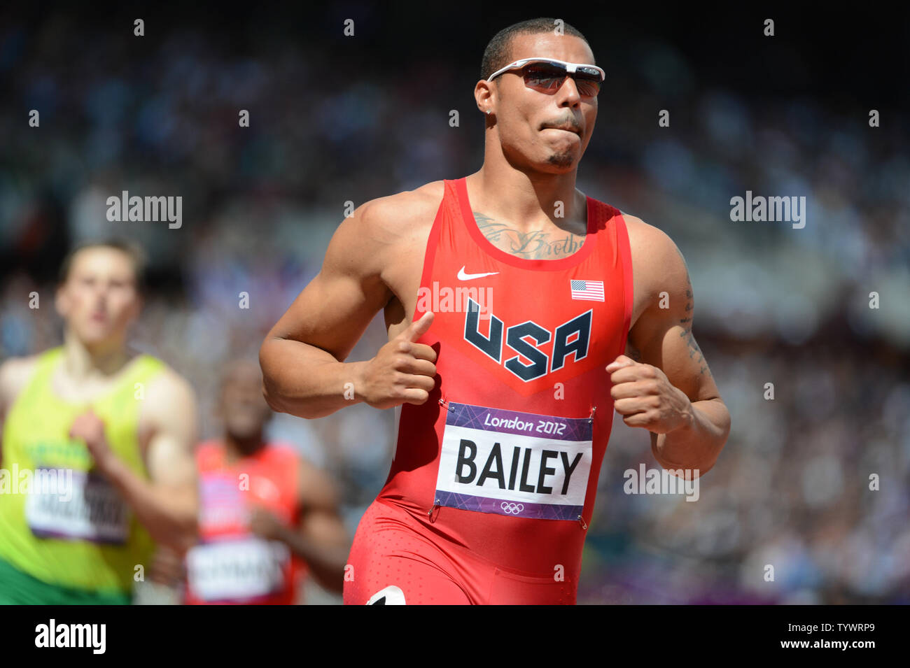 Ryan Bailey of the USA (R) crosses the finish line of round one of the ...