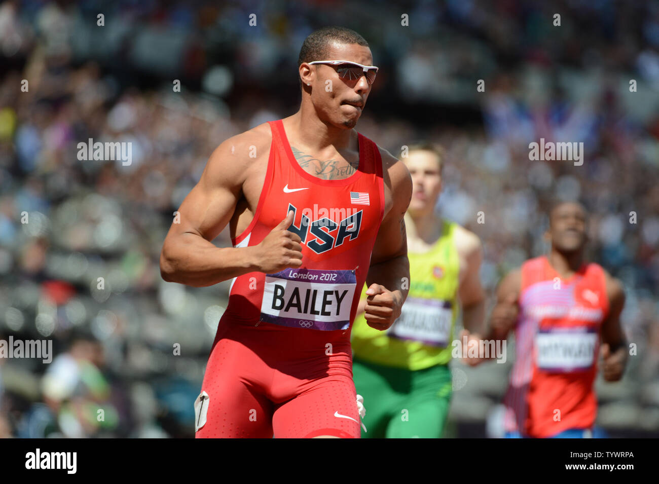 Ryan Bailey of the USA (R) crosses the finish line of round one of the ...