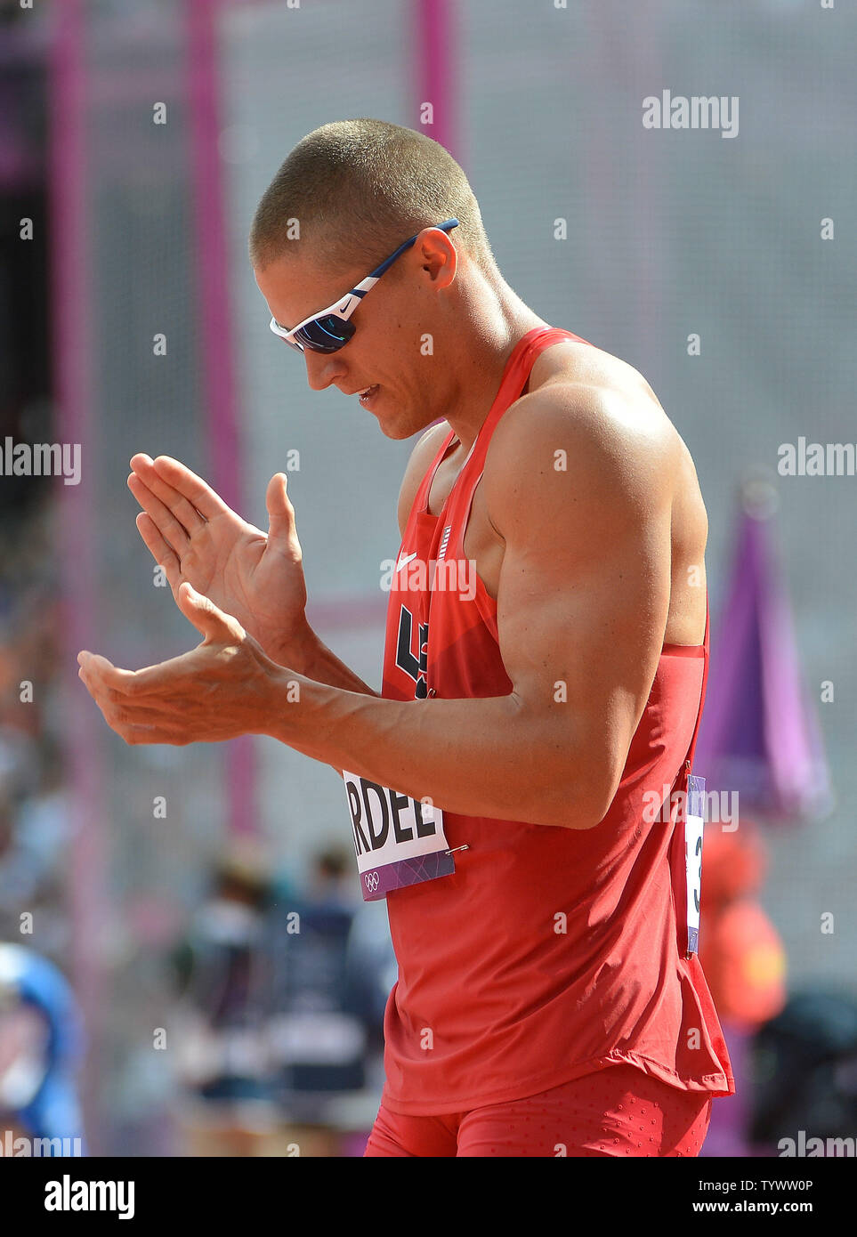 Trey Hardee of the United States claps after finishing the 100M of the ...