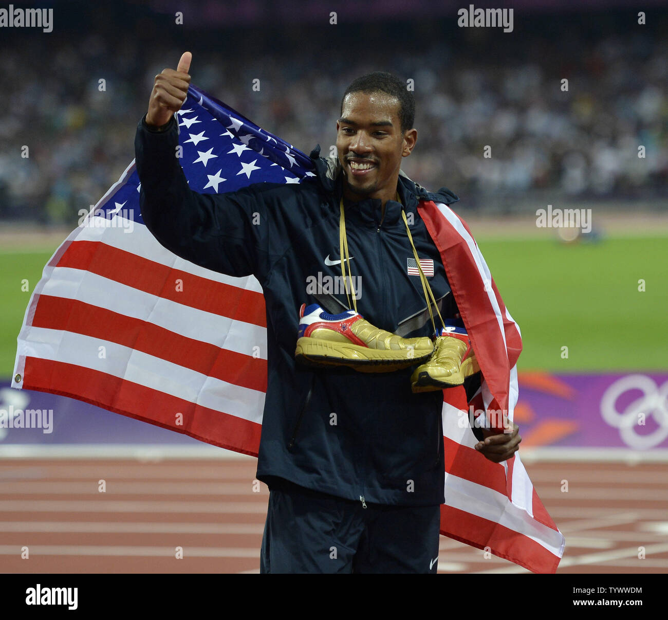 Gold Medalist Taylor Christian of the United States takes a victory lap ...