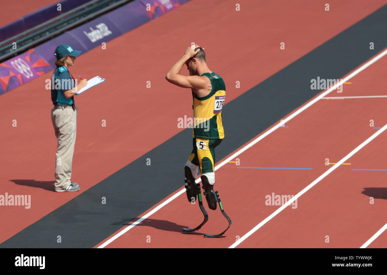 South Africa's Oscar Pistorius holds his head in his hands after his ...