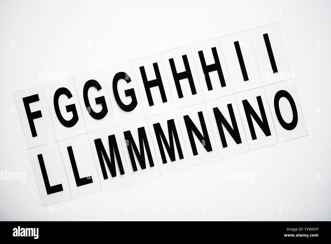 Black capitalize letter on white table background Stock Photo - Alamy