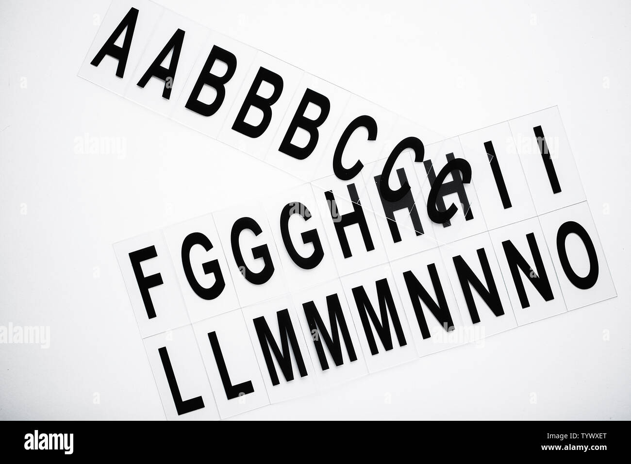 Black capitalize letter on white table background Stock Photo - Alamy