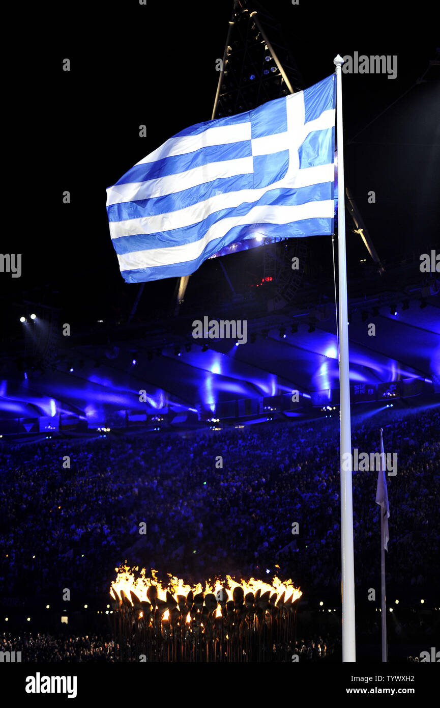 The Greek flag flies as the national anthem of Greece is played during ...