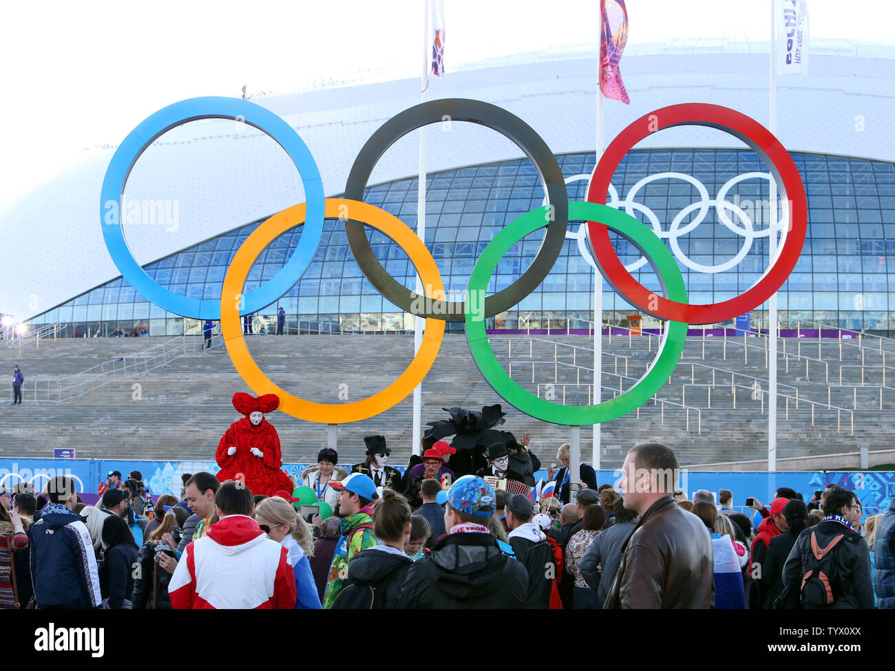 Visitors play around giant Olympic rings erects in front of the Bolshoi ...