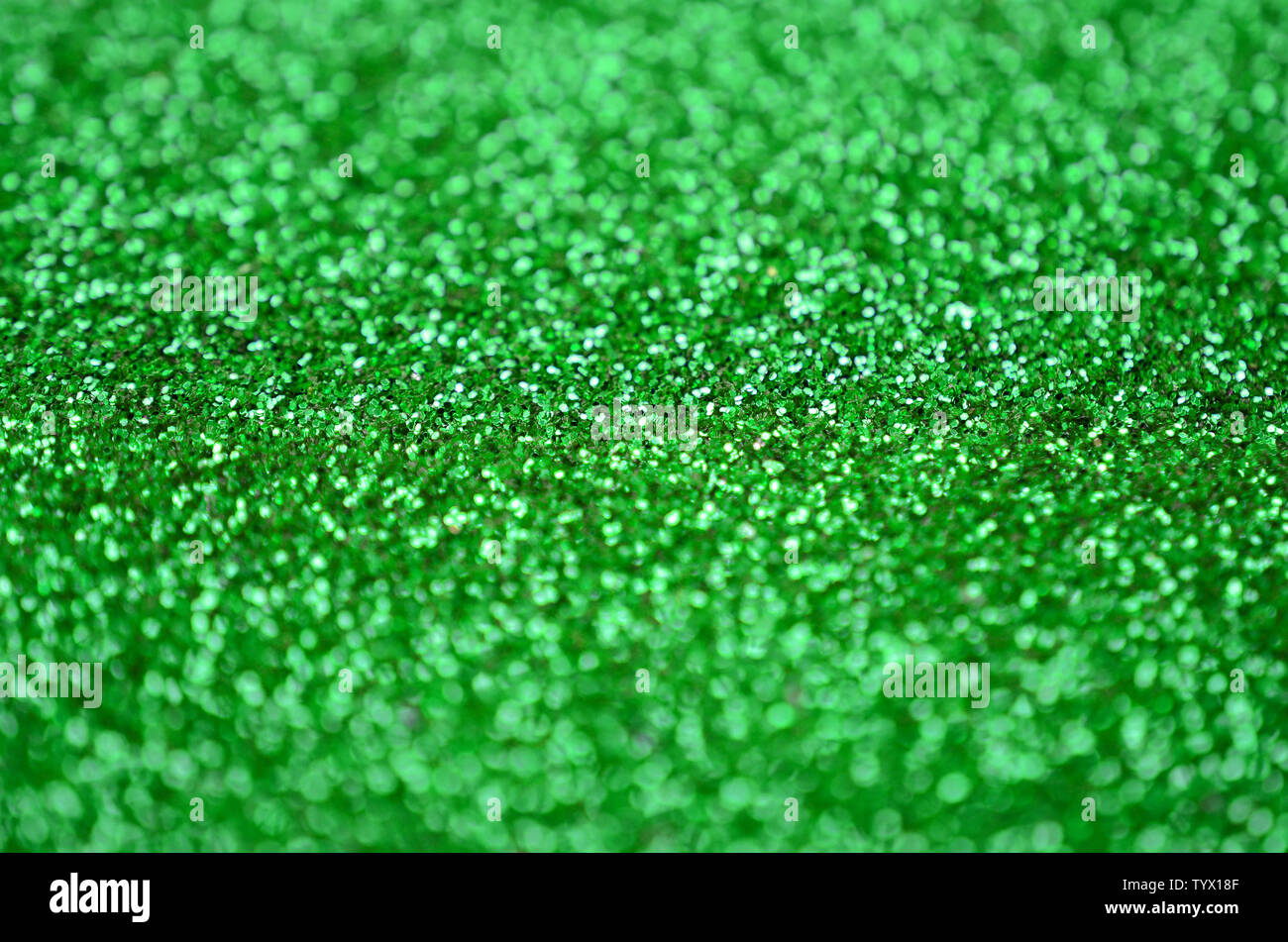 A huge amount of green decorative sequins. Background image with shiny ...