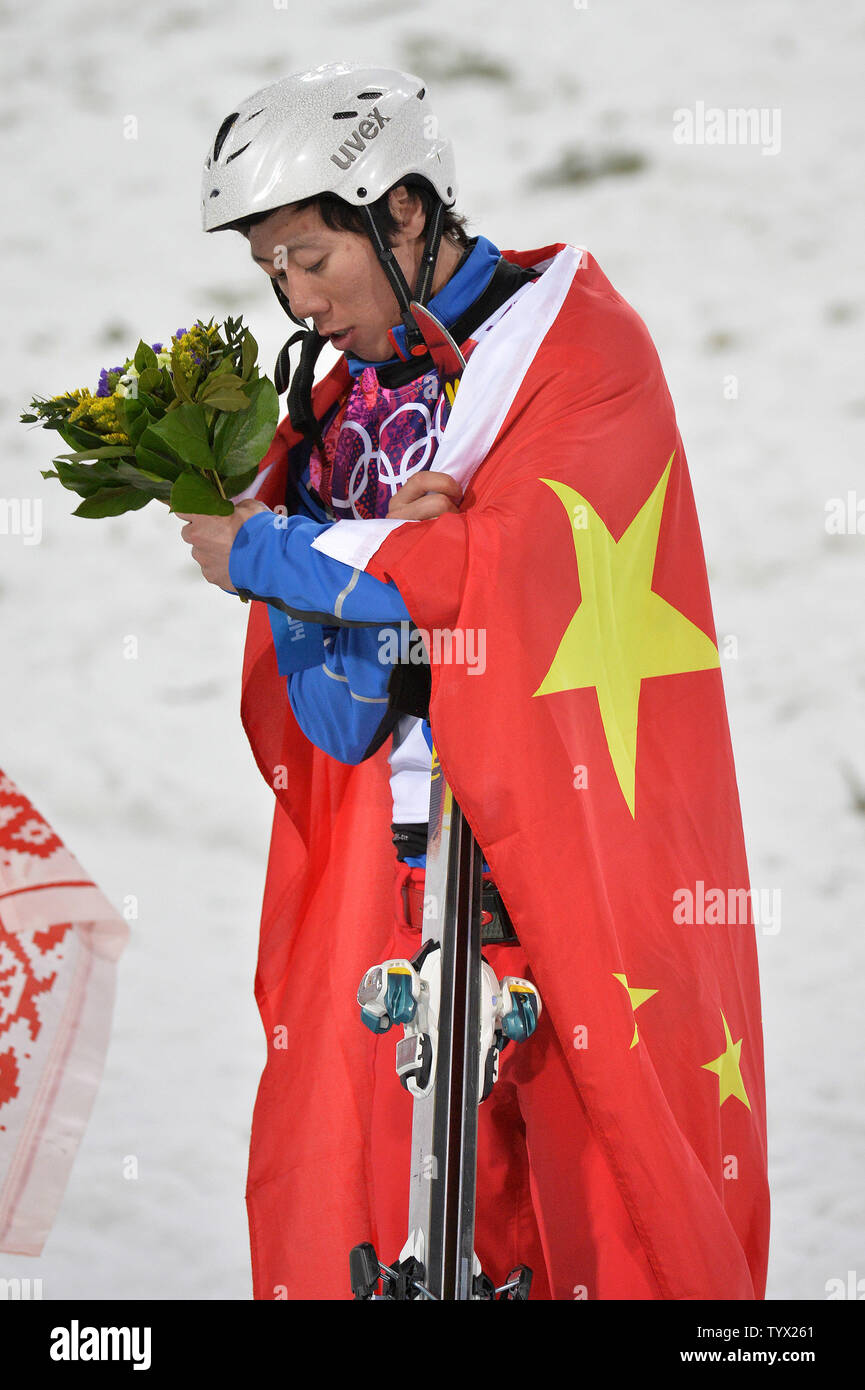 China's Zongyang Jia stands with the Chinese flag after winning bronze ...