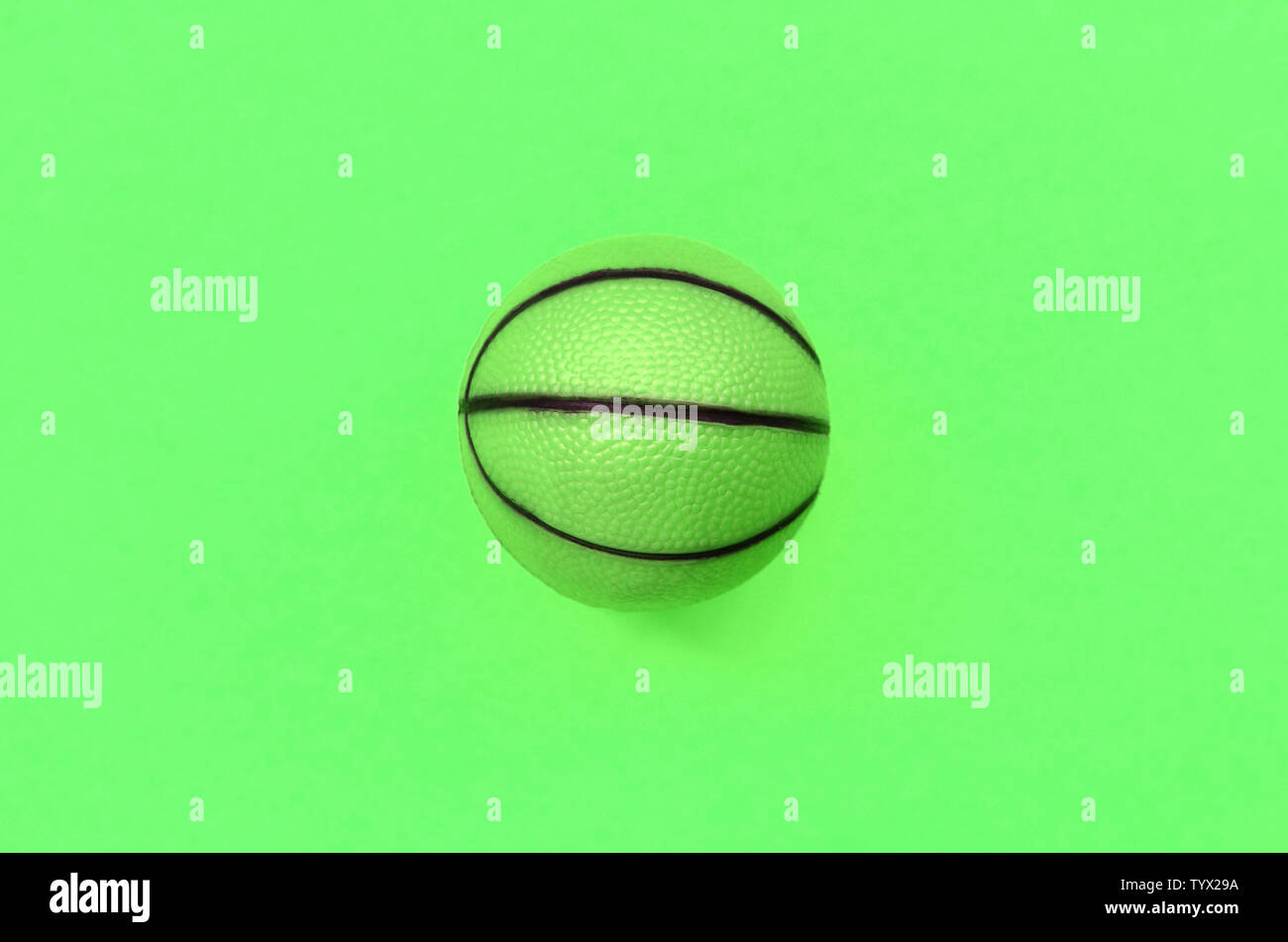 Small green ball for basketball sport game lies on texture background ...