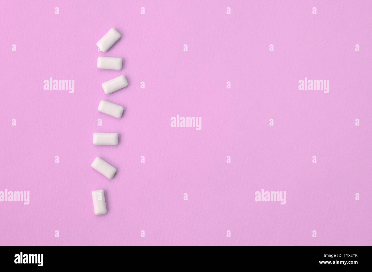 A few chewing gums lie on texture background of fashion pastel pink ...