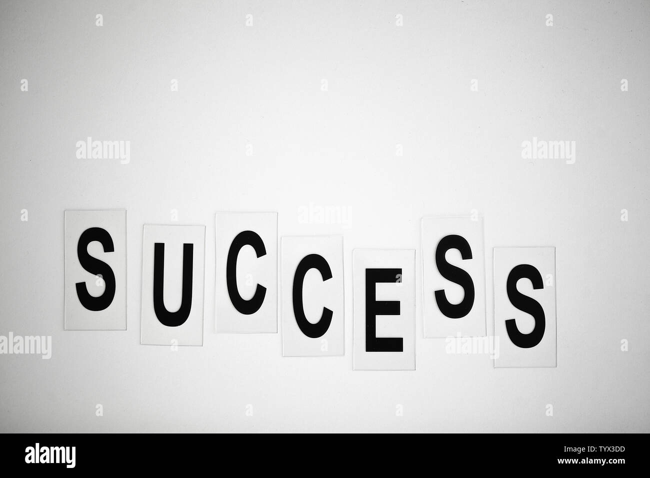 Success word written on white table. Copy space Stock Photo - Alamy