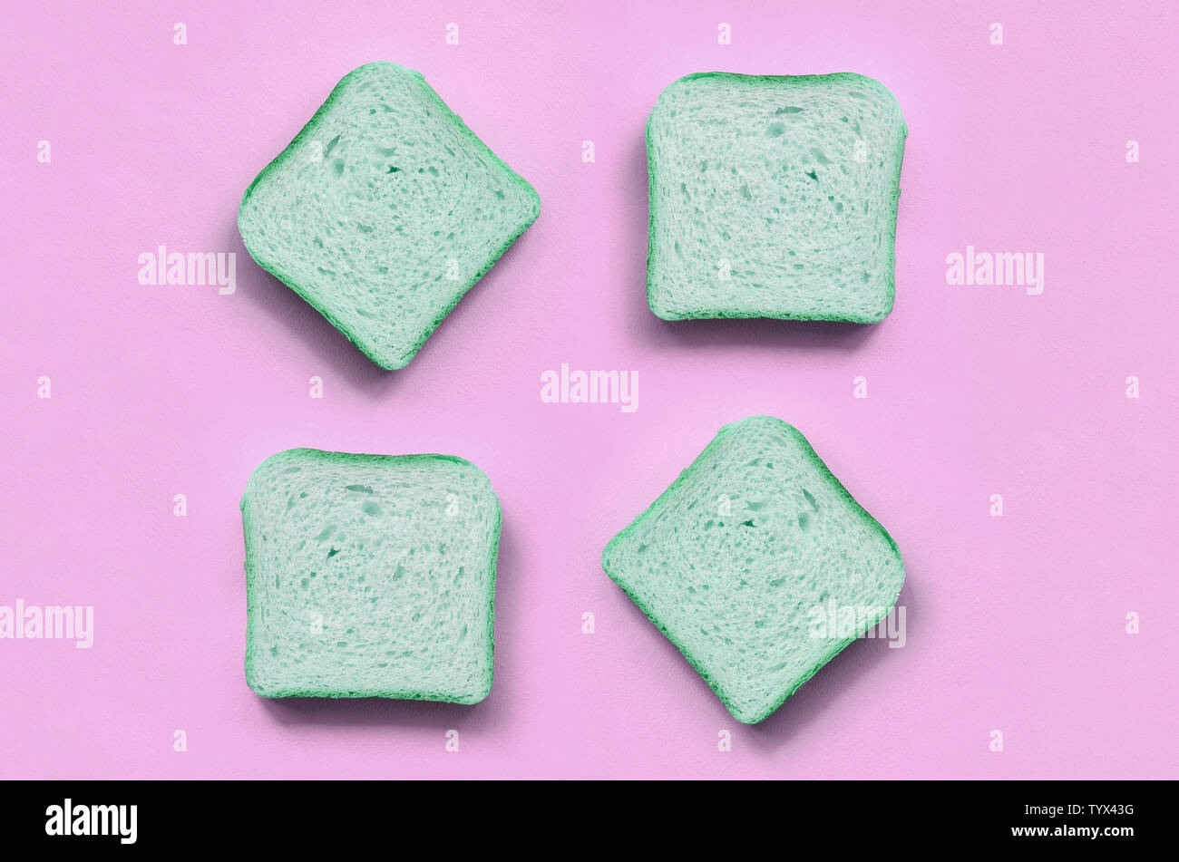 A few pieces of green bread lies on texture background of fashion ...