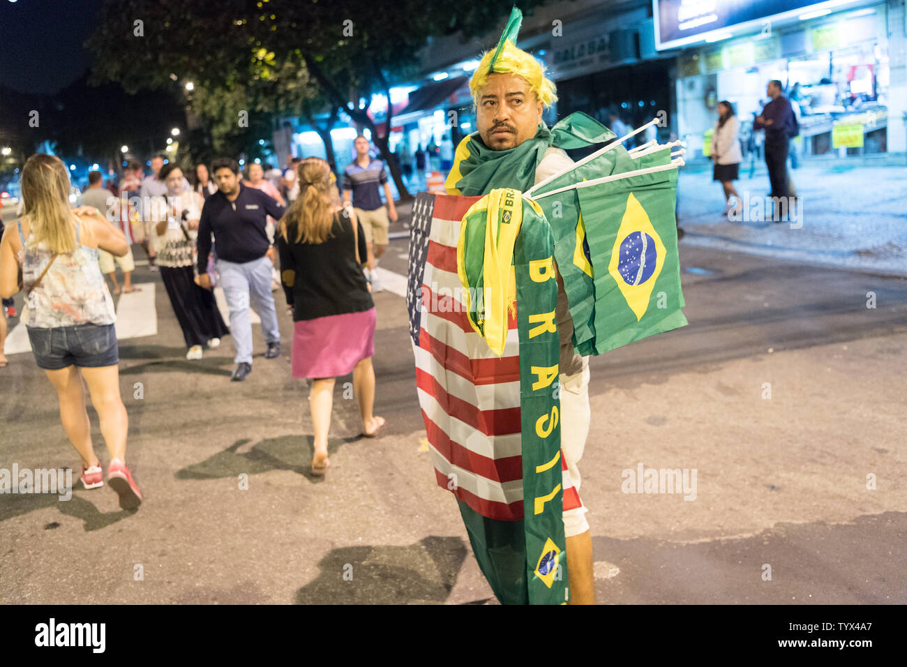 A Brazilian man selling national flags for the opening ceremonies ...