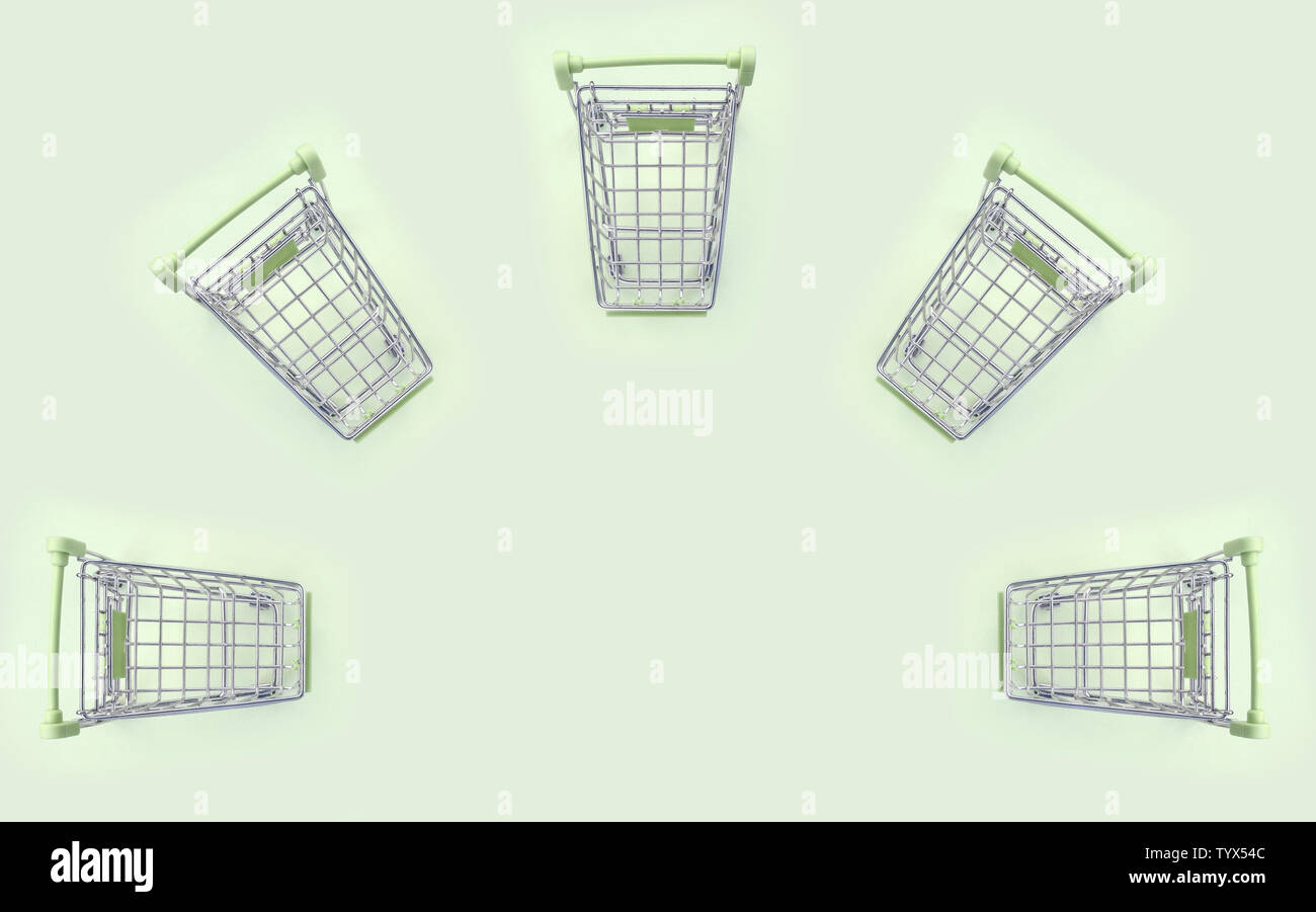 Pattern of many small shopping carts on a lime background. Minimalism ...