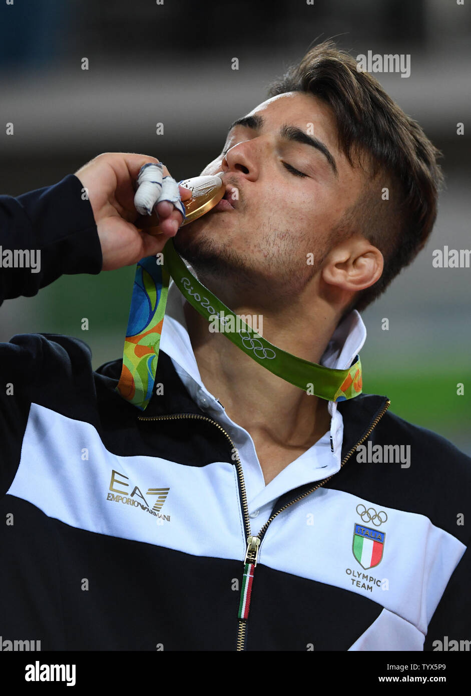 Italy's Fabio Basile kisses his medal after winning the gold in the 66 ...